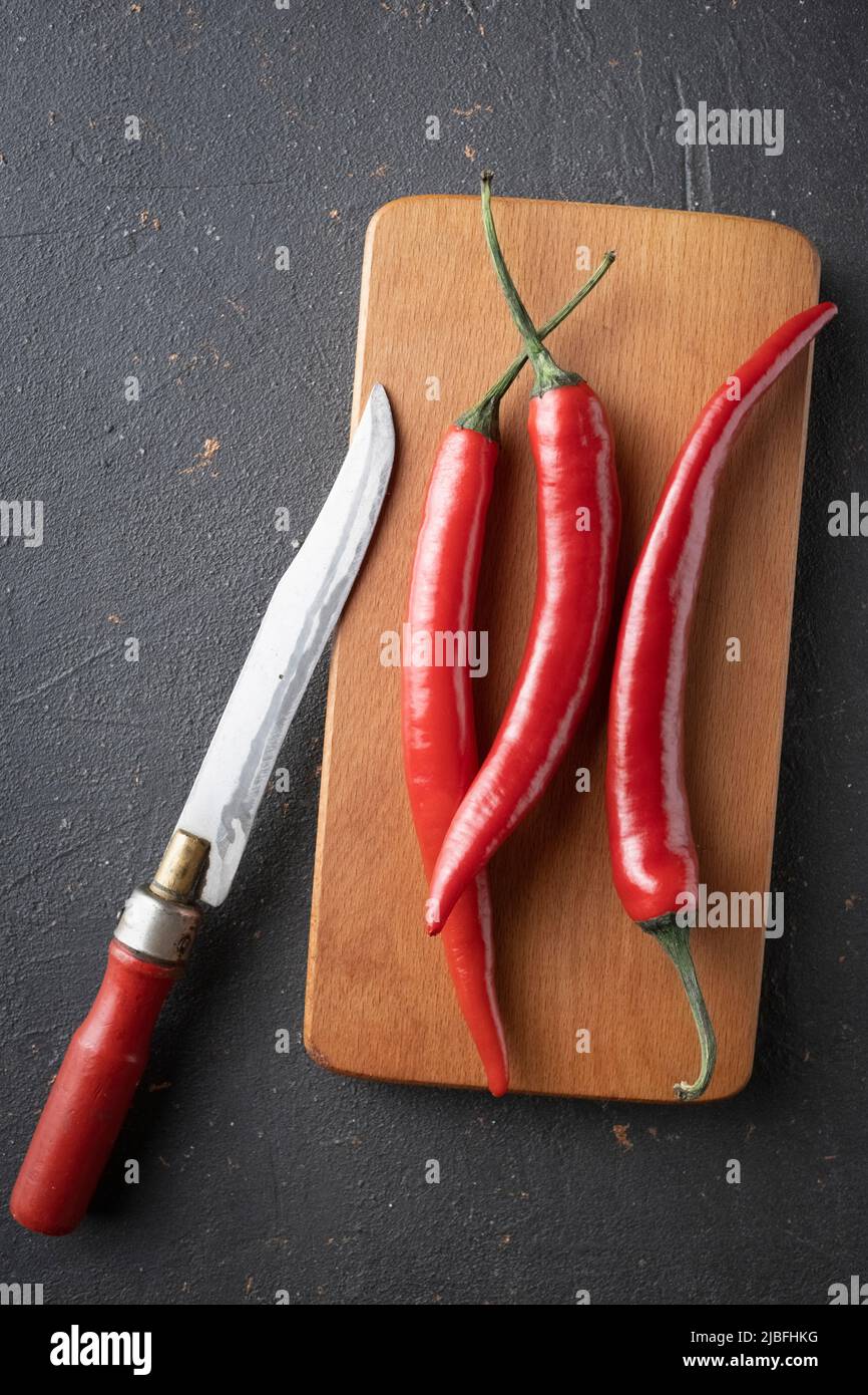 Hot chili pepper pods on a cutting board, close-up, still life Stock ...