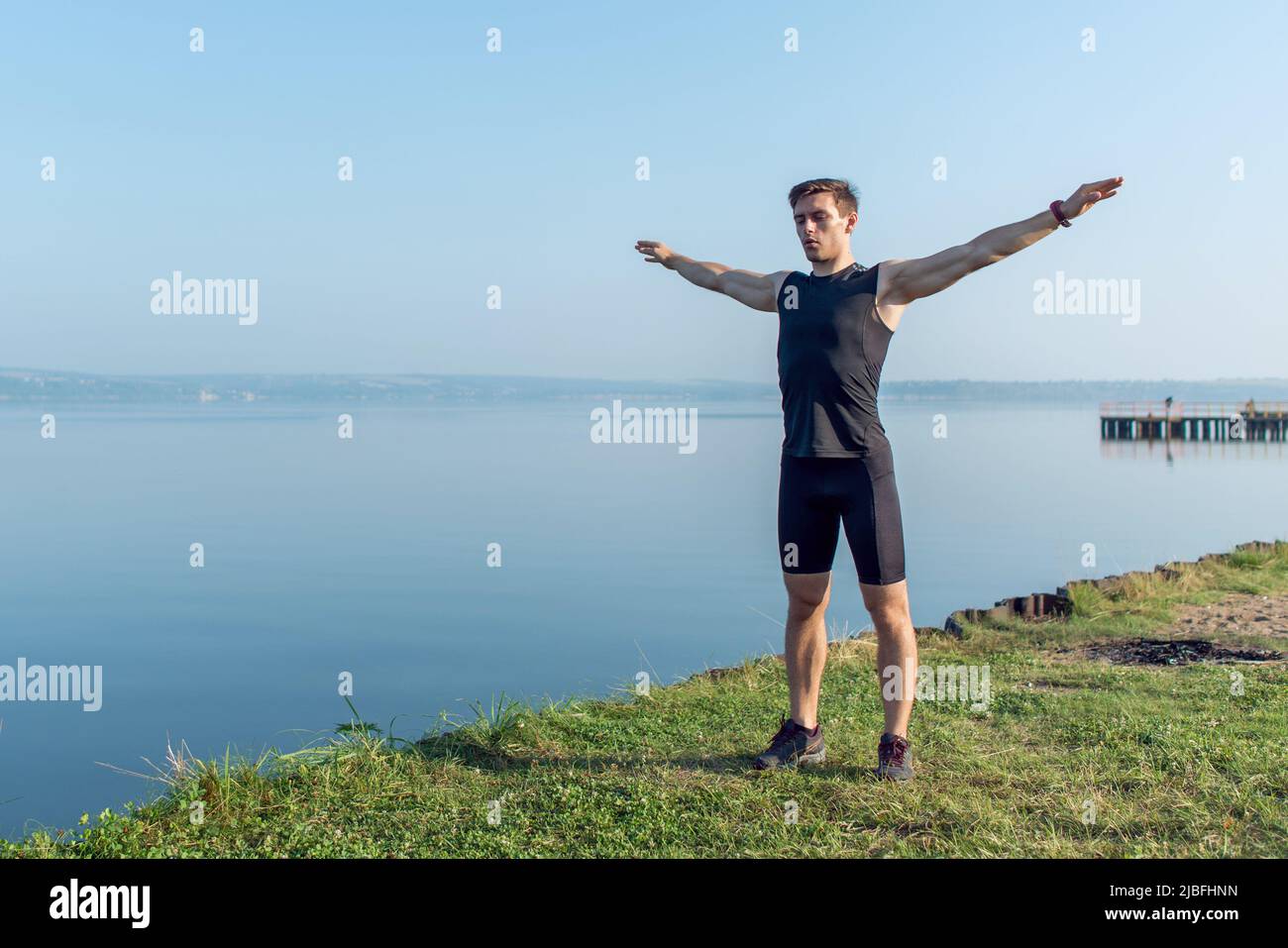 Fit young man preparation for running workout warming up before a run ...