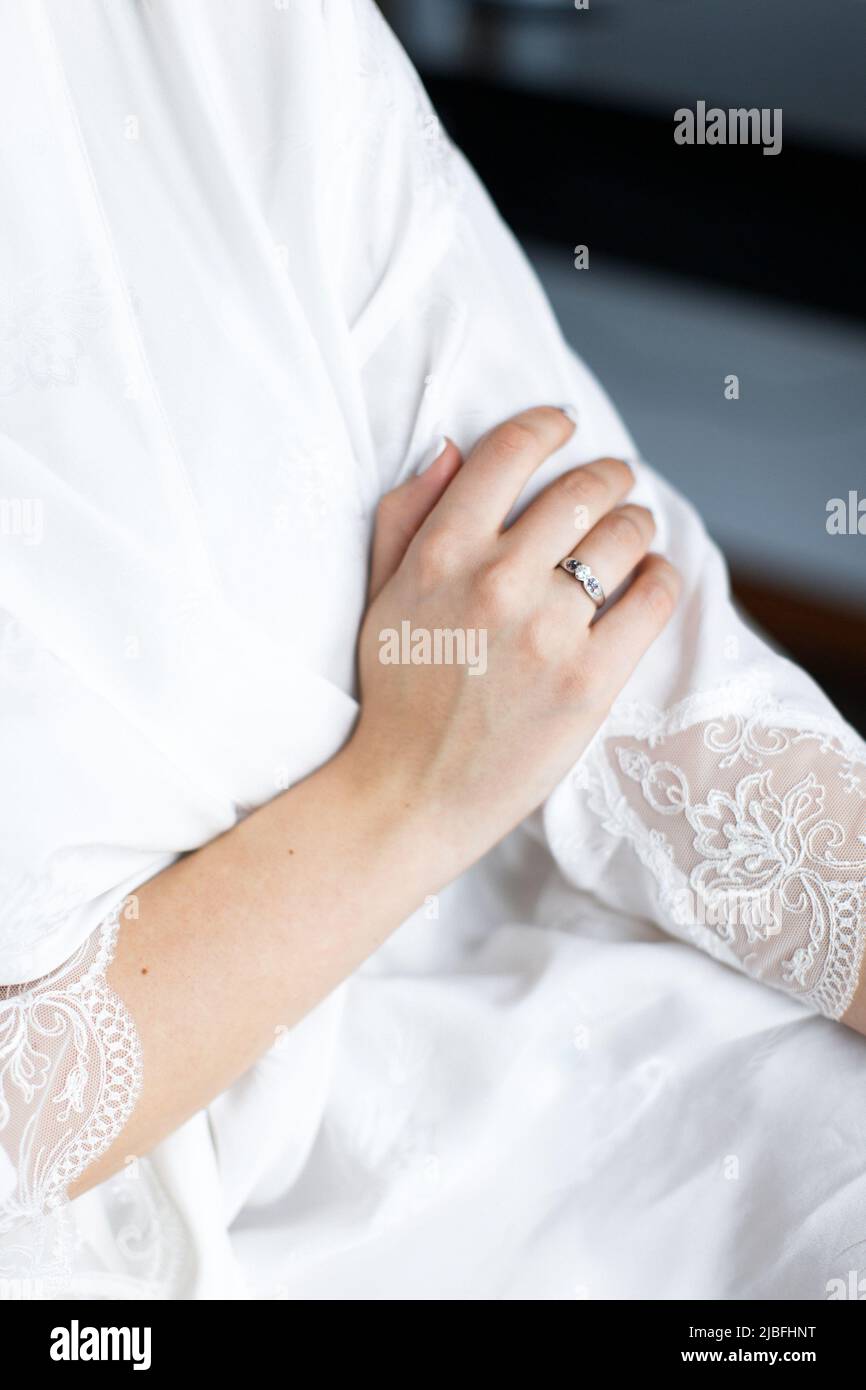 Engagement ring on bride's finger. Wedding day Stock Photo - Alamy