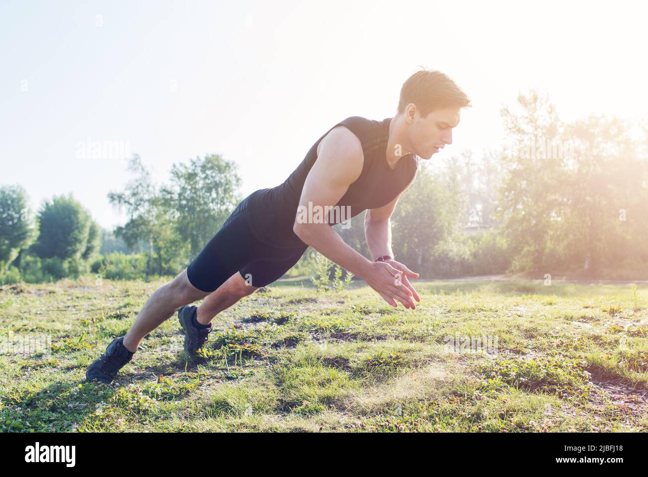 Fitness man doing clapping push-ups exercise intense training outdoors ...
