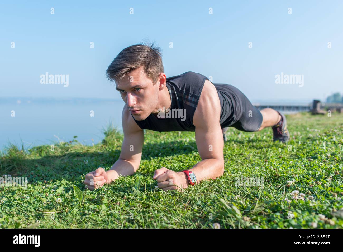 Fitness man working out his midsection core muscles doing plank ...