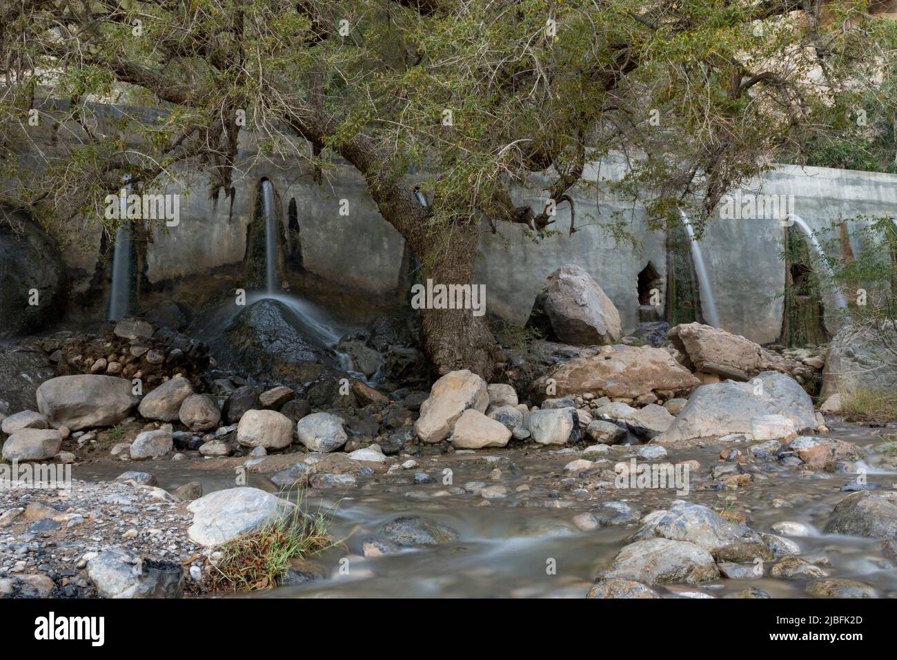 Water flowing through stone channels in Wadi Tanuf near Nizwa, Oman ...