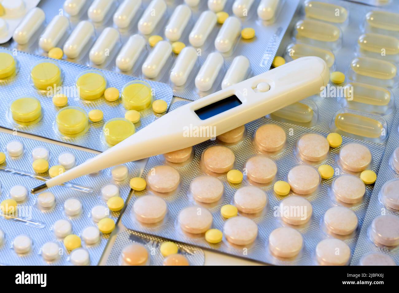 Thermometer on supplements and pills blister packs background. Pack of ...