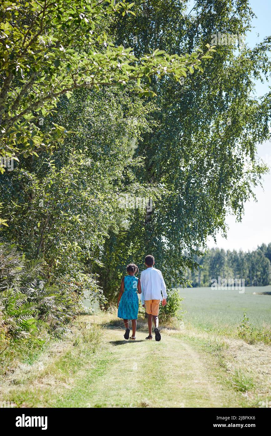 Siblings walking in forest hi-res stock photography and images - Alamy