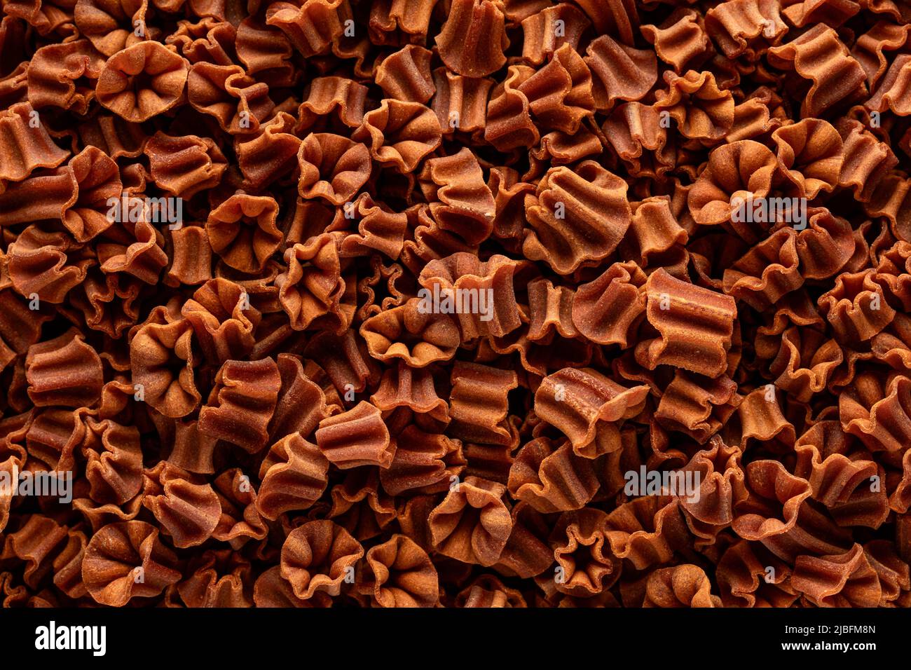 Top view of raw ribbon-shaped pasta Stock Photo - Alamy