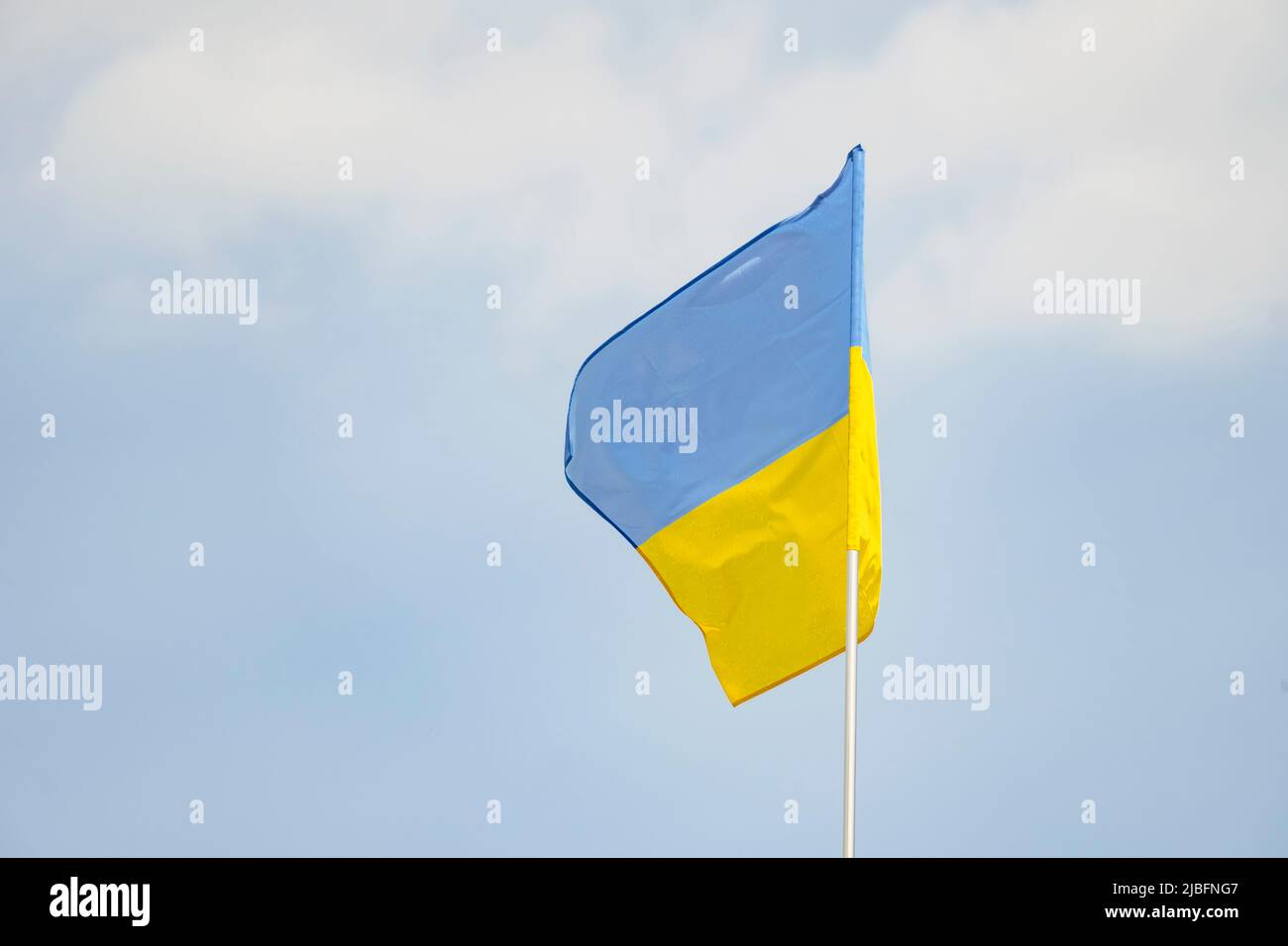 National flag of Ukraine against blue sky. Independence Day ...