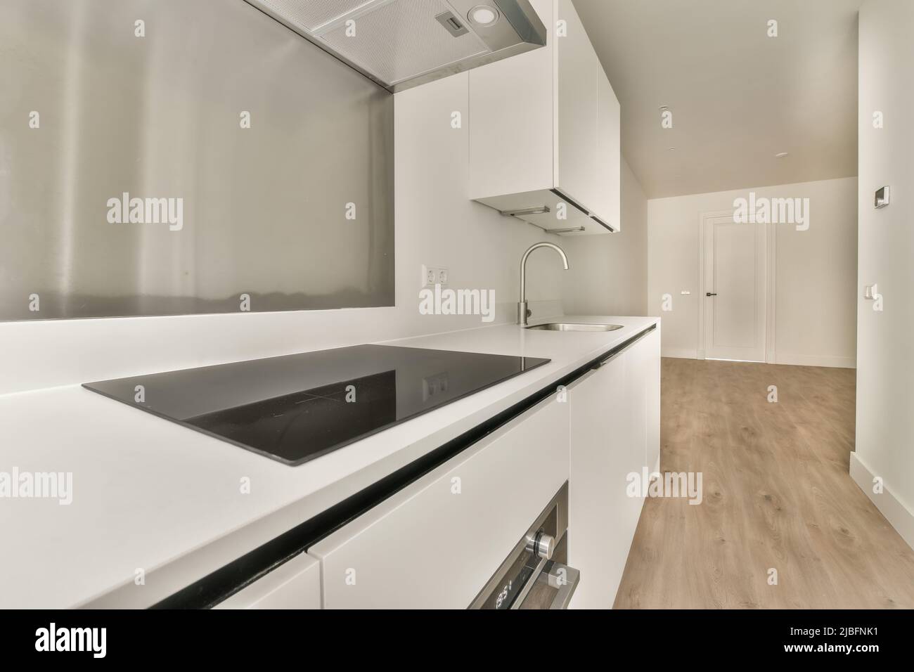 Counter with white cabinets in light spacious kitchen with window in ...