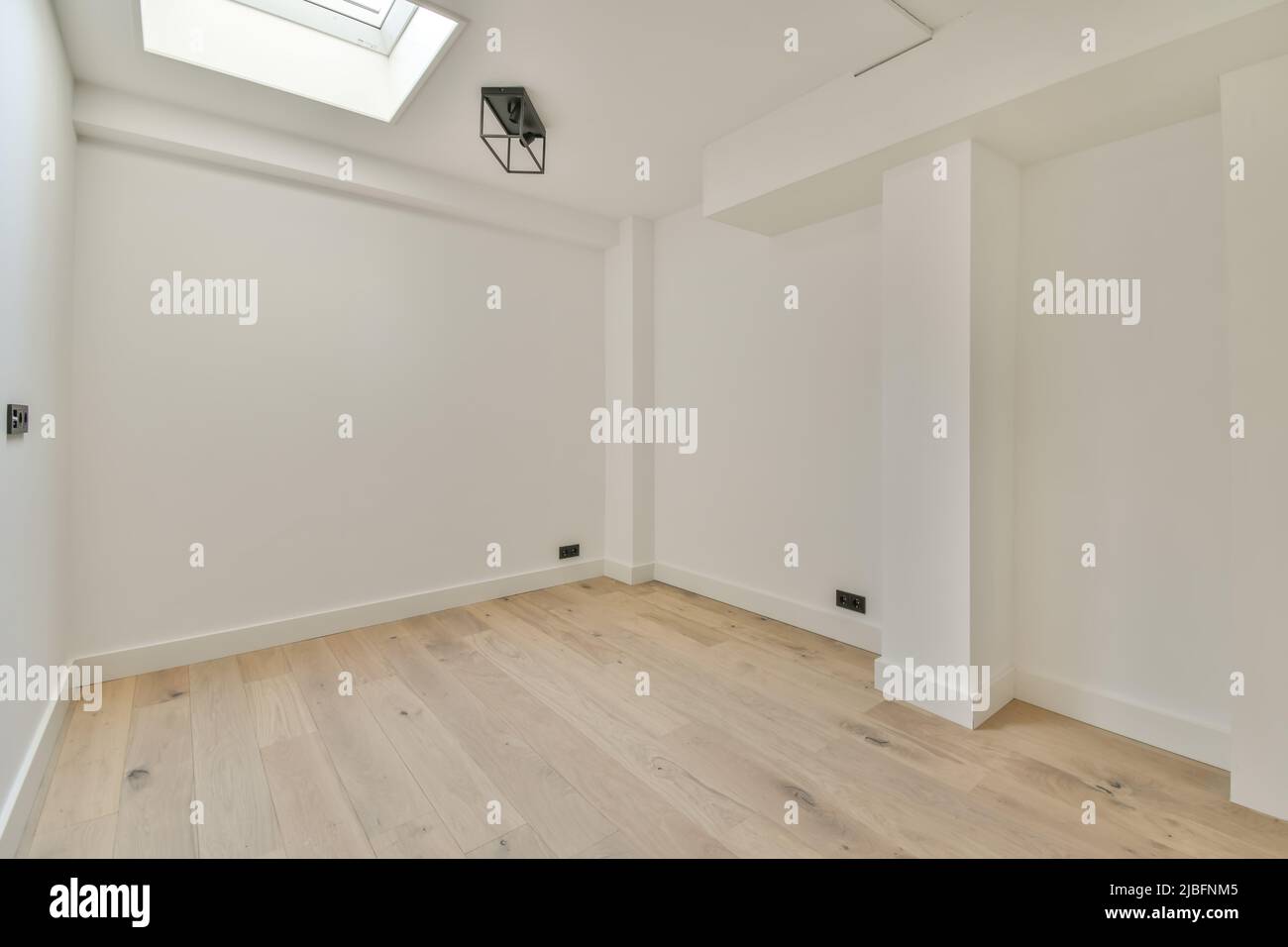 Interior of spacious empty refurbished room with whitewash walls ...