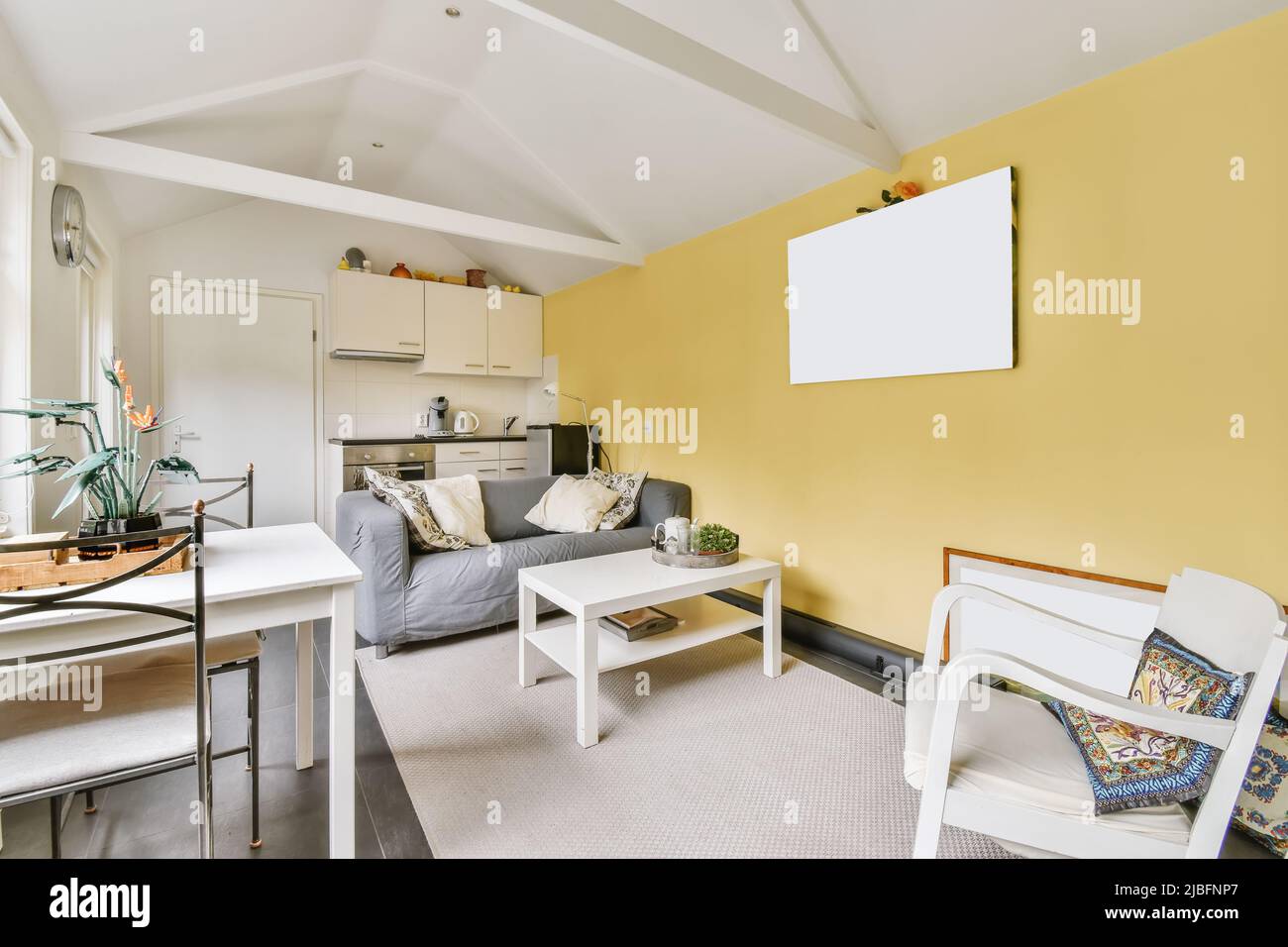 Lounge and dining area with modern furniture near kitchen in small ...