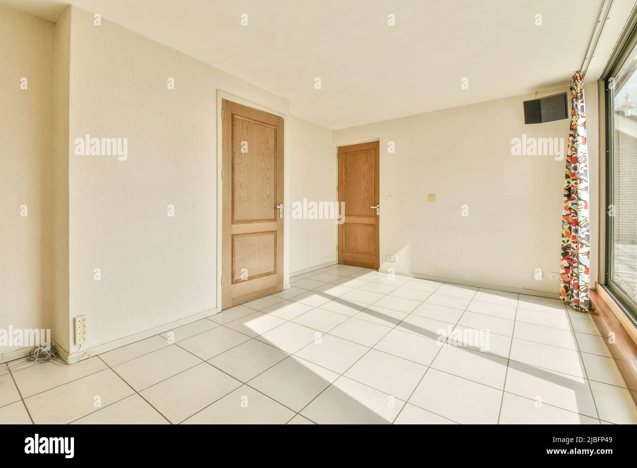 Wooden doors and panoramic window in spacious corridor of modern house ...