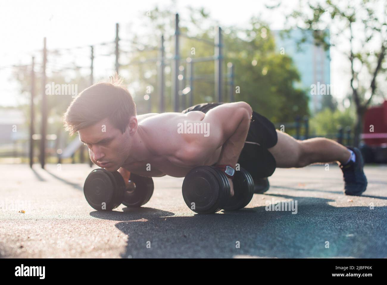 Muscular male athlete doing push ups exercises Stock Photo - Alamy