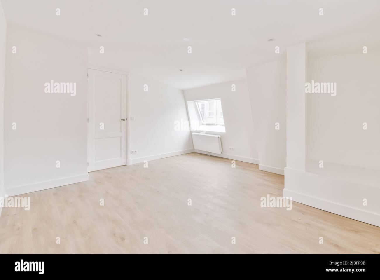 Interior of spacious empty refurbished room with whitewash walls ...