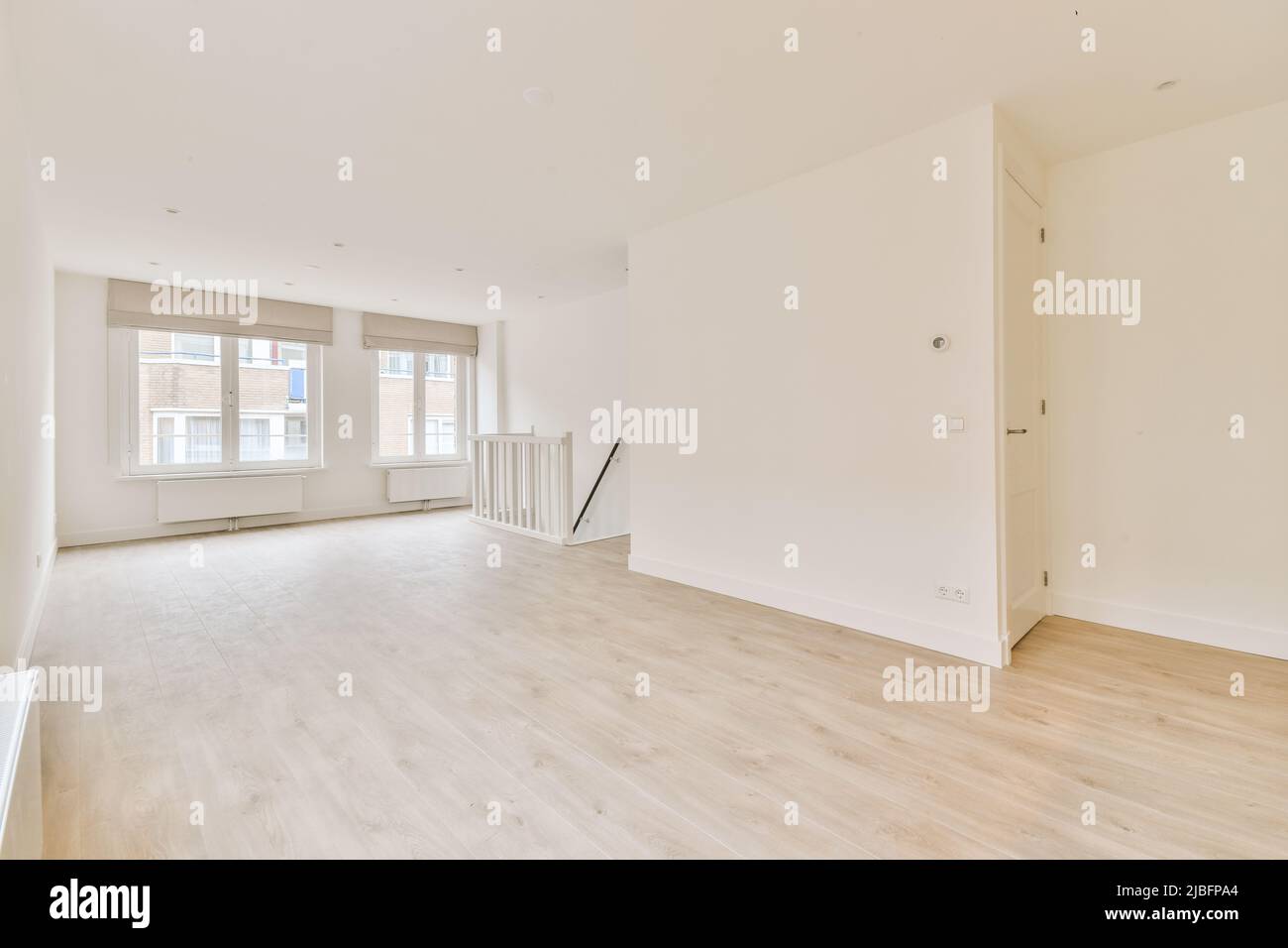 Interior of spacious empty refurbished living room with whitewash walls ...