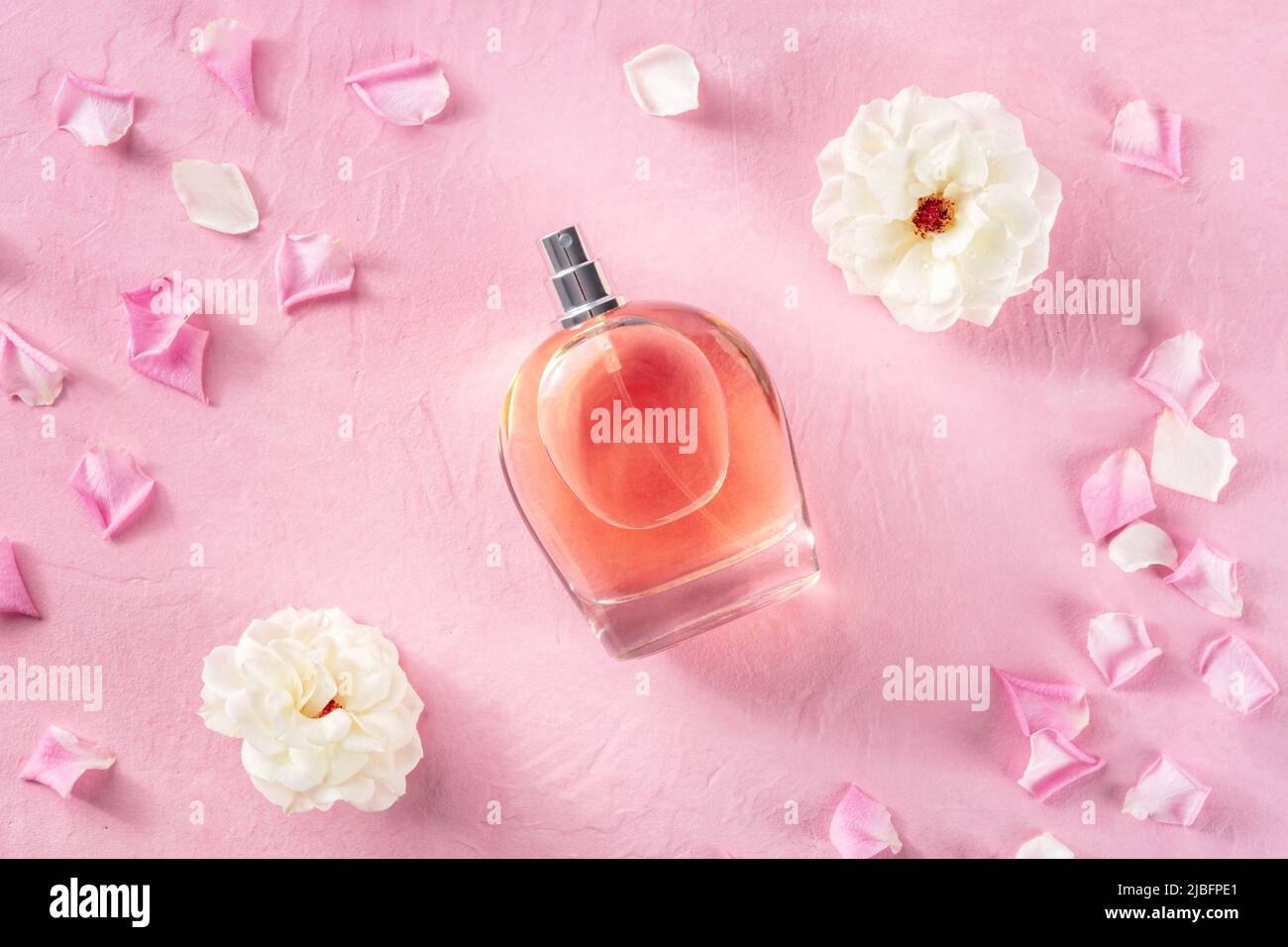 Perfume concept. A bottle of rose fragrance, overhead flat lay shot on ...