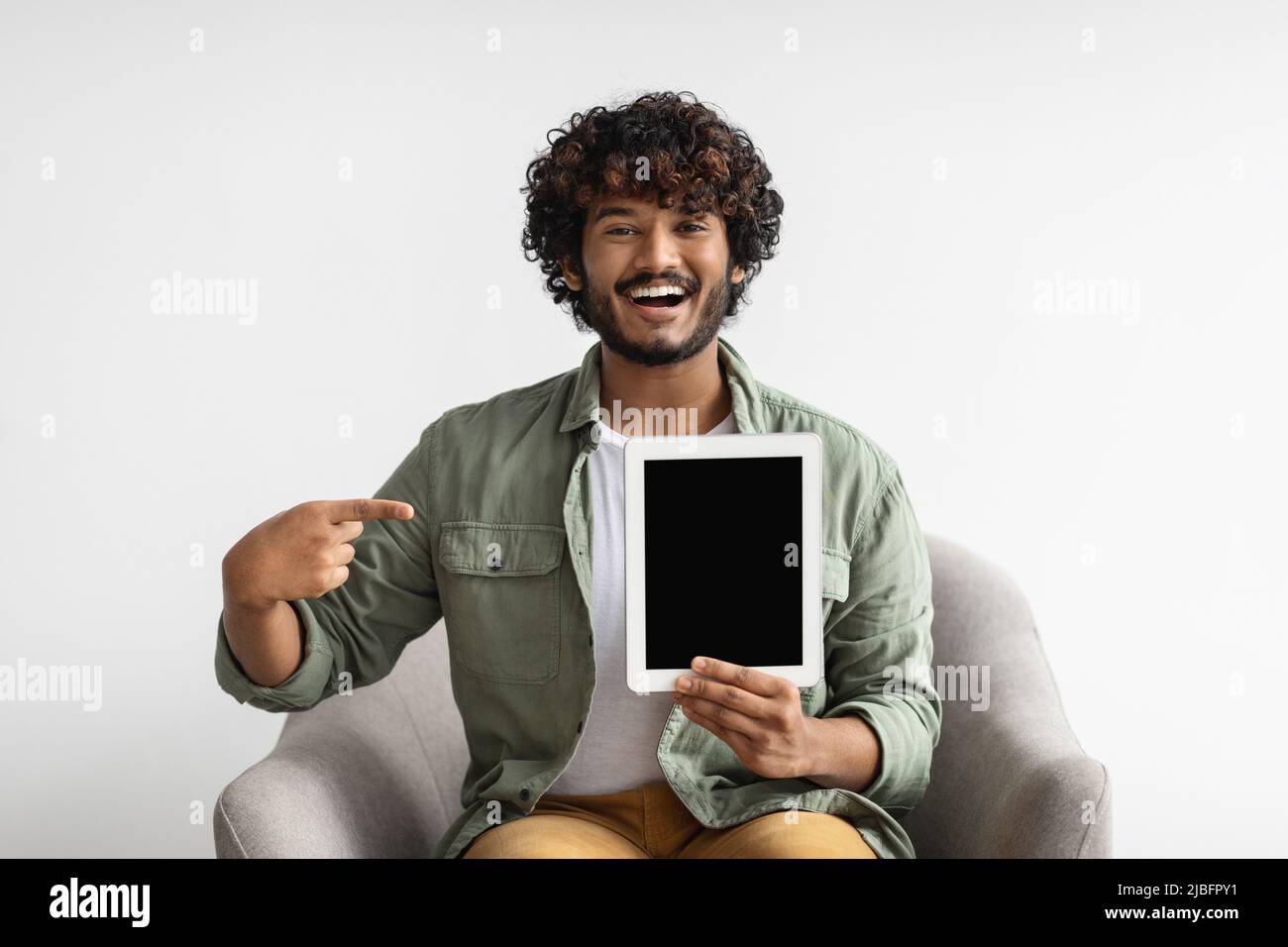 Happy indian man pointing at tablet with empty screen Stock Photo - Alamy