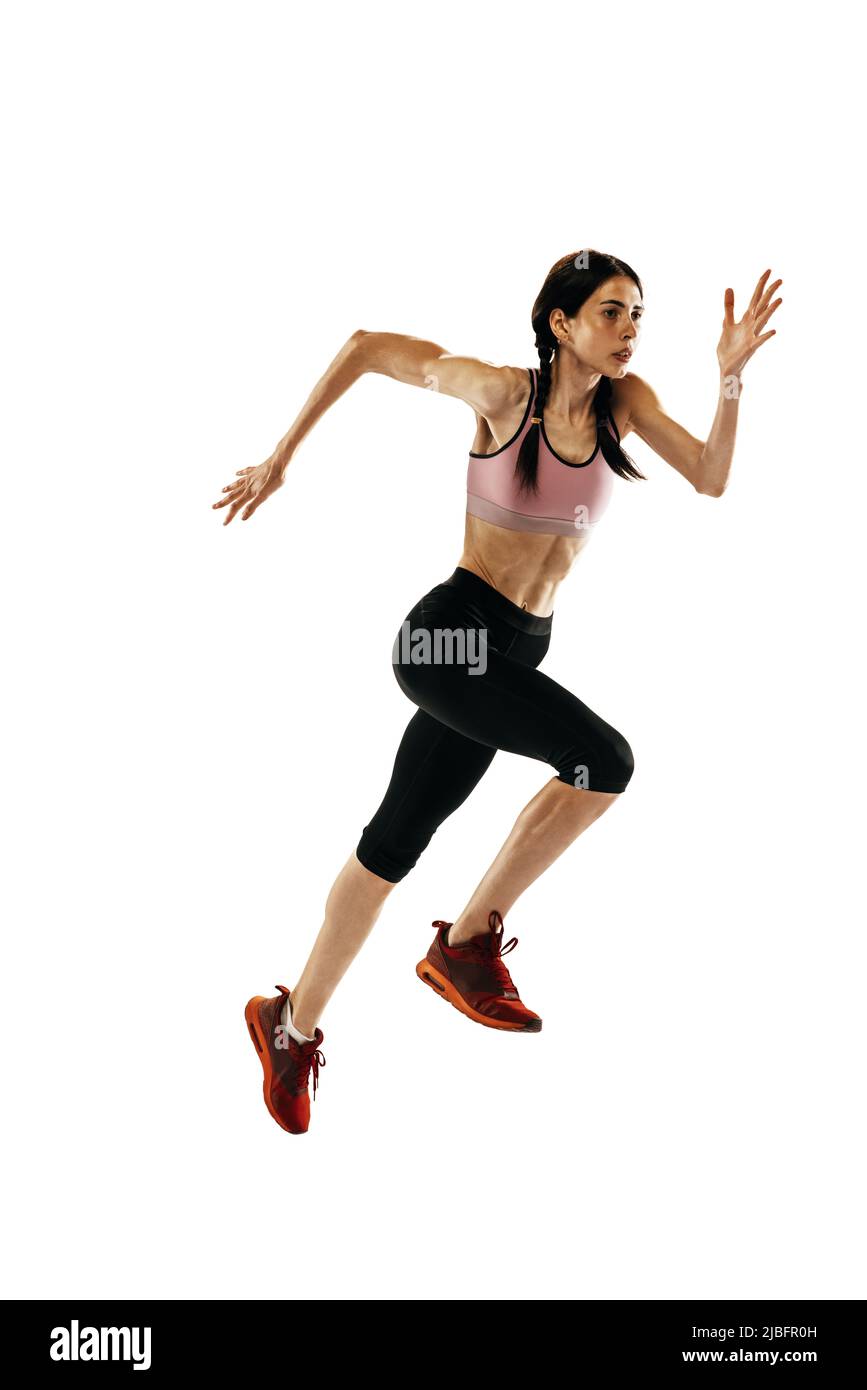 Young caucasian woman running isolated on white studio background. One ...