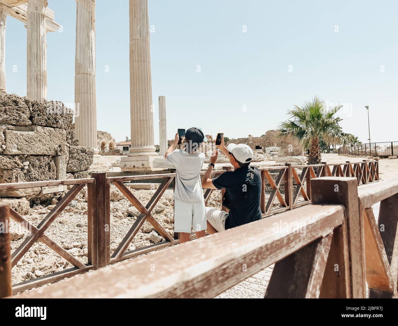 Young father dad and his school boy kid son tourists taking photos of ...
