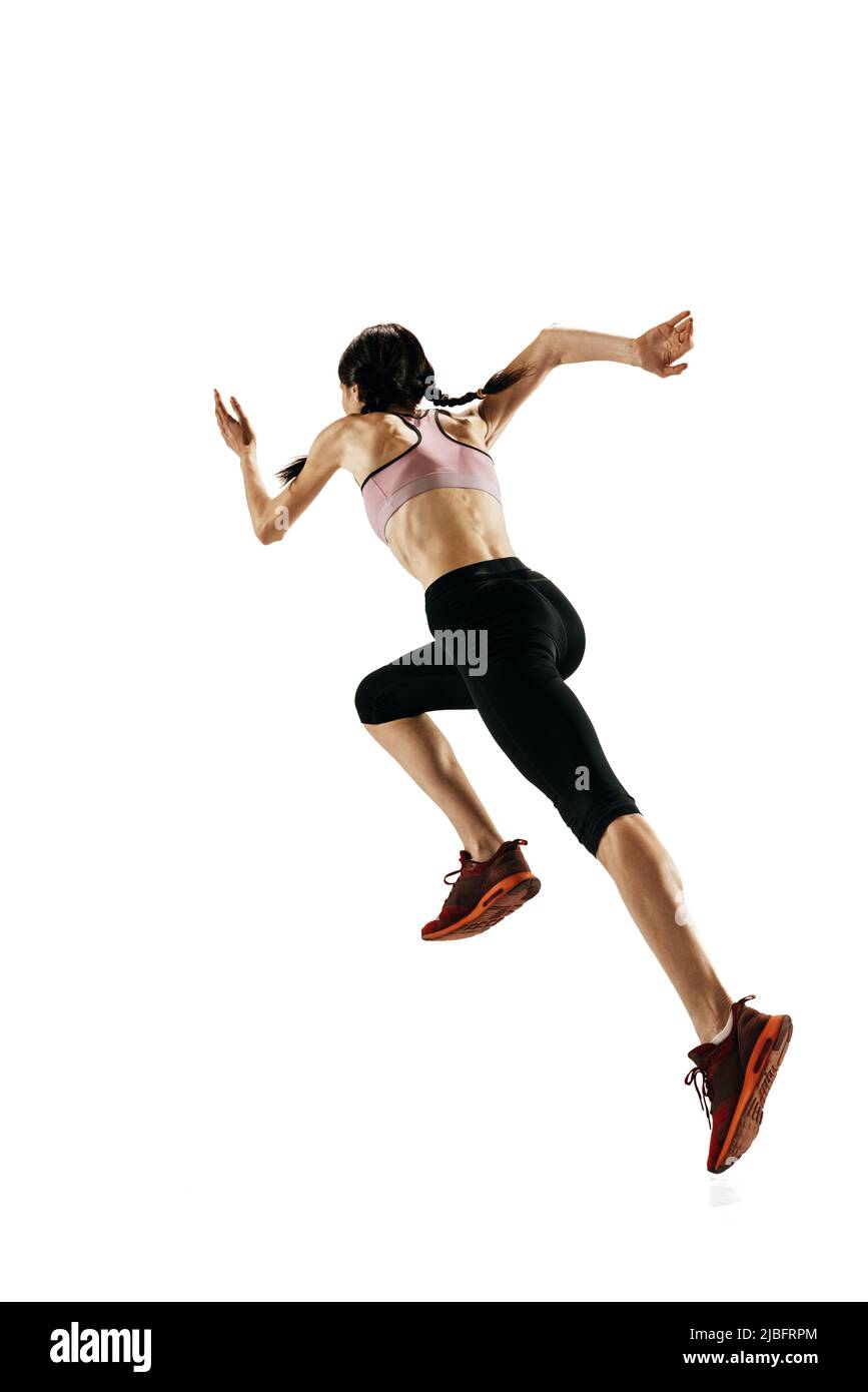 Rear view of young caucasian woman running isolated on white studio ...