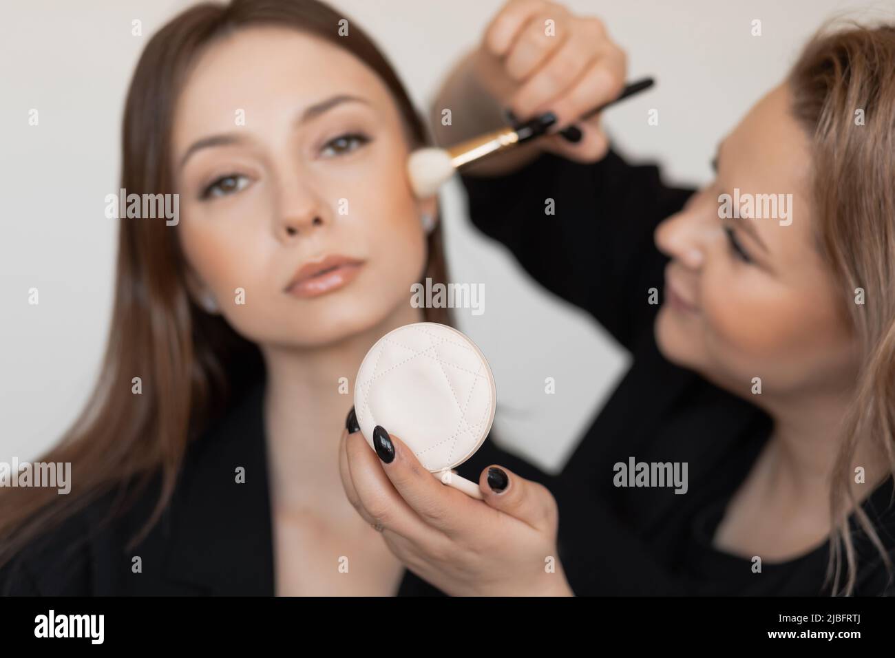 Blurred woman face brushing with perfect healthy shining skin applying ...