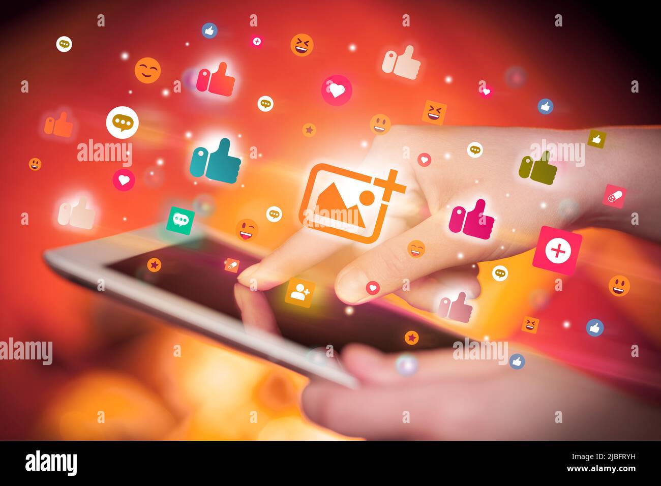 Close-up of a hand using tablet with social media icons Stock Photo - Alamy