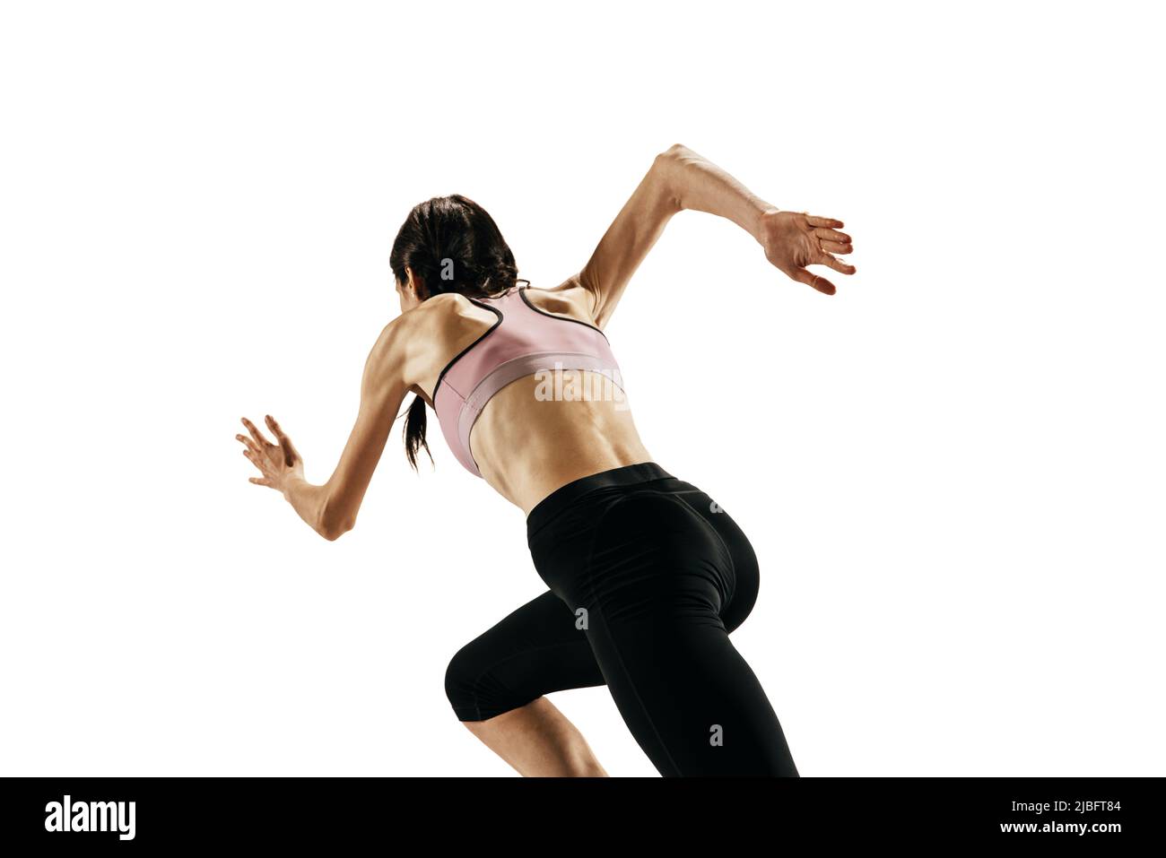 Rear view of young caucasian woman running isolated on white studio ...