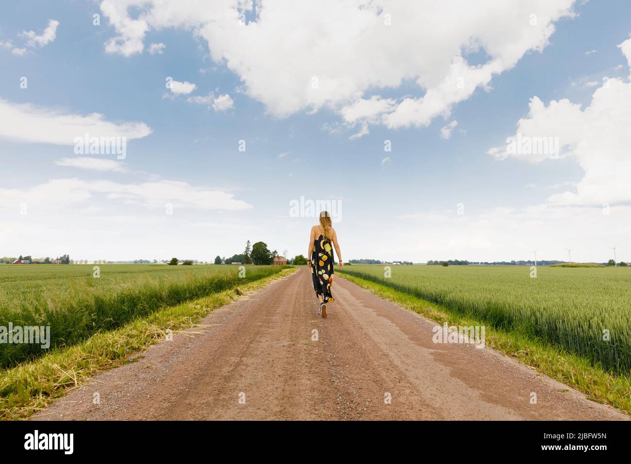 Woman walking on rural road hi-res stock photography and images - Alamy