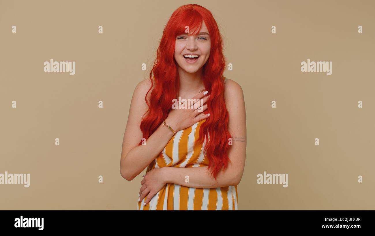 Joyful redhead woman laughing out loud after hearing ridiculous ...