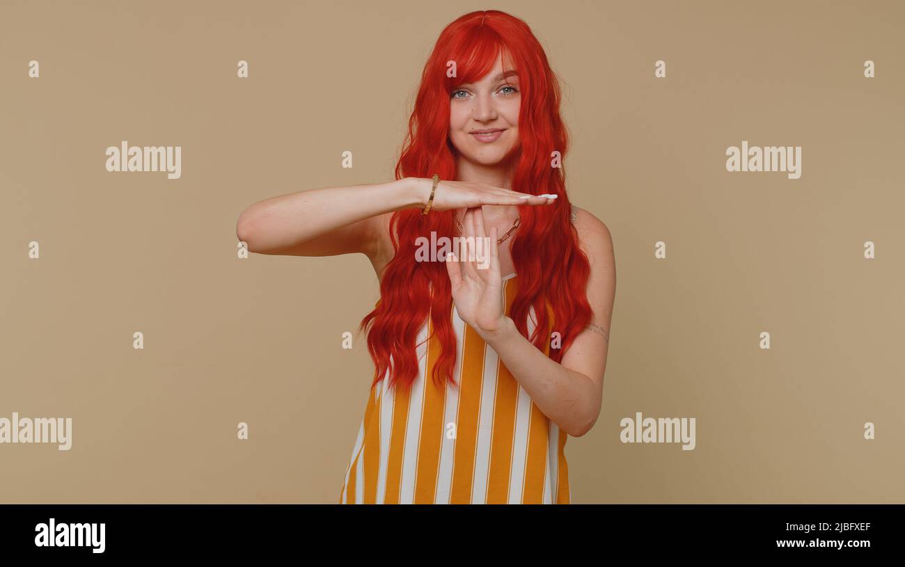 Tired serious upset ginger woman in tank top showing time out gesture ...