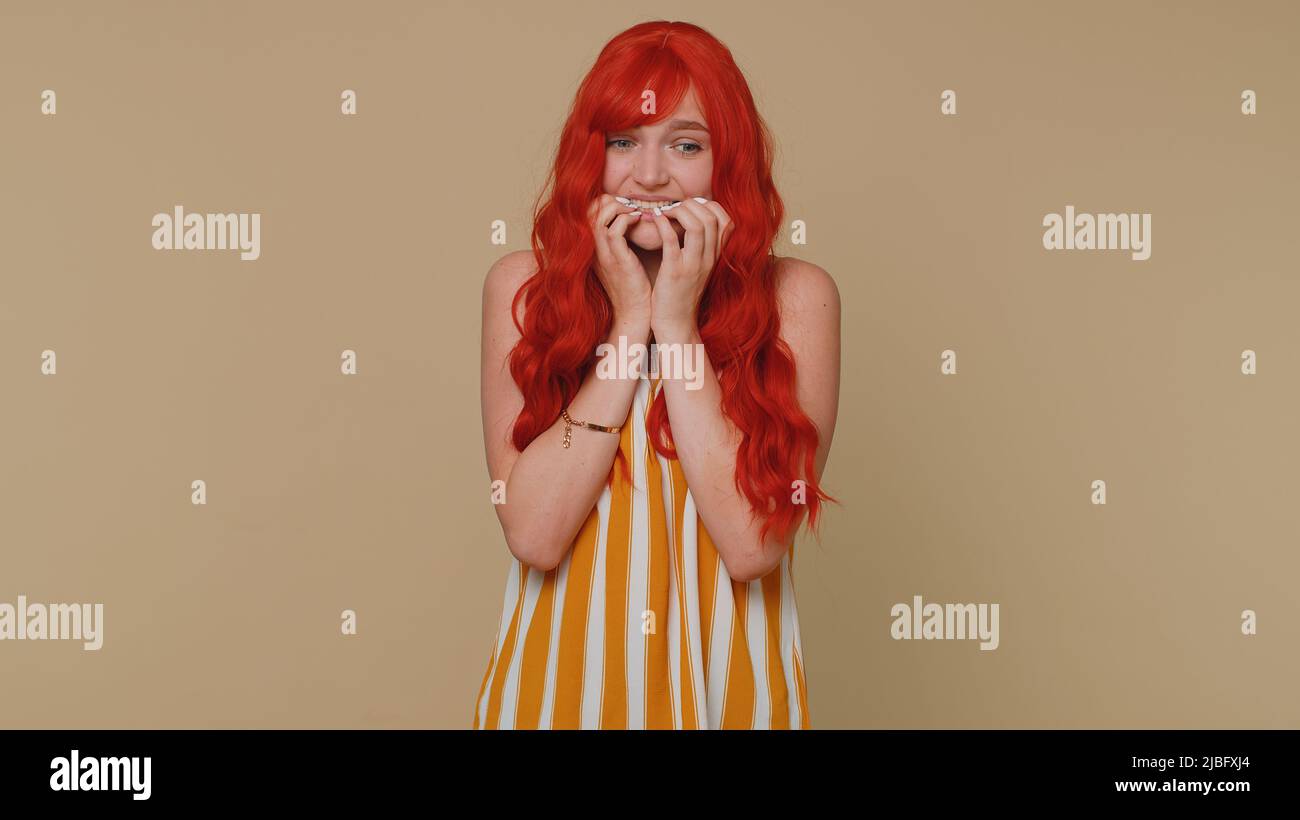 Panic attack. Upset scared frightened redhead woman biting nails ...