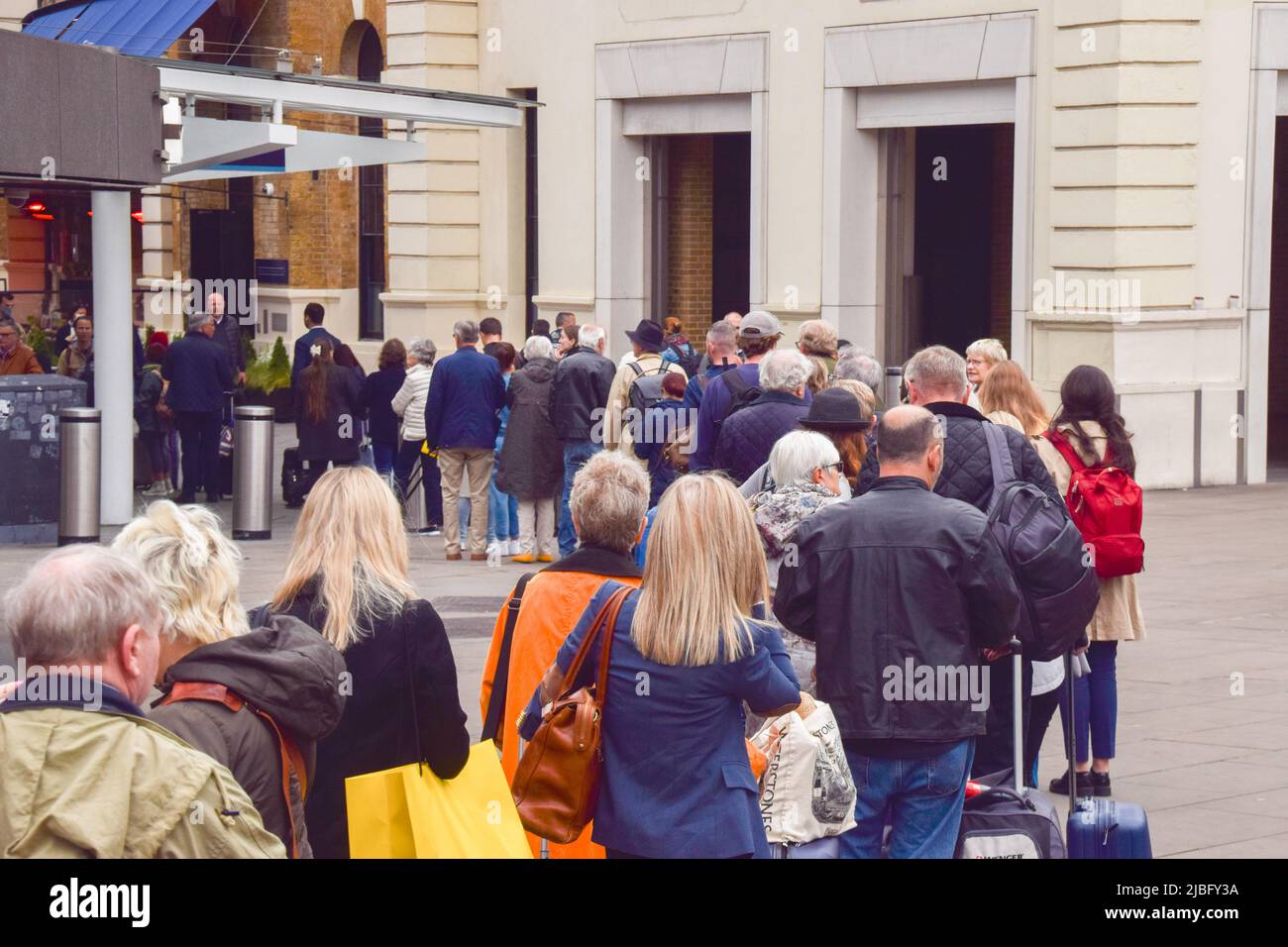 London, UK. 6th June 2022. A long queue forms at a taxi rank outside ...