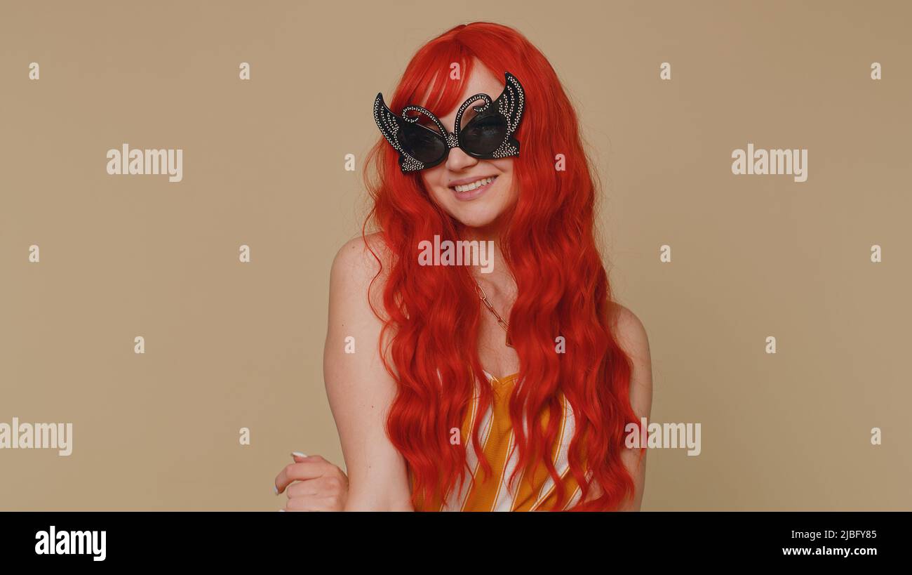 Portrait of seductive cheerful stylish redhead woman in tank top ...