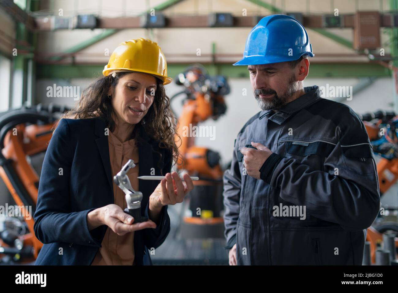 Female engineering manager and mechanic worker doing routine check up ...