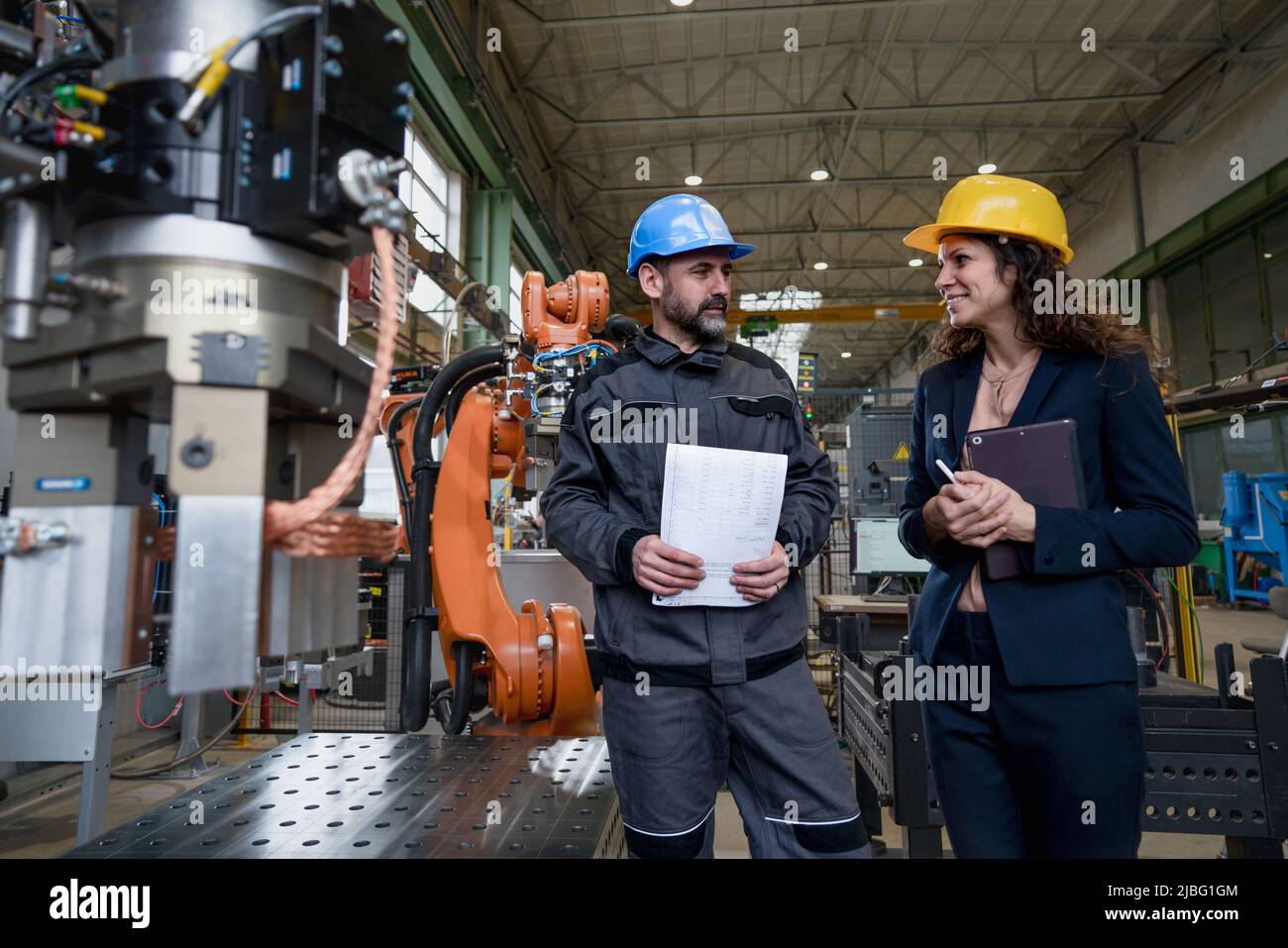 Female engineering manager and mechanic worker doing routine check up ...