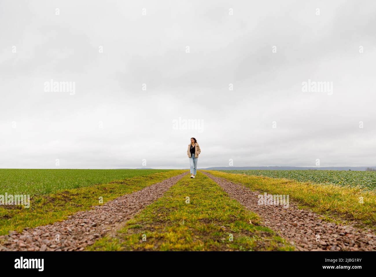 Woman walking on rural road hi-res stock photography and images - Alamy