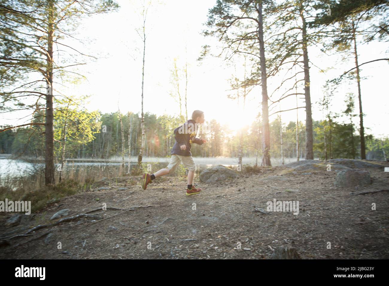 Boy running into lake hi-res stock photography and images - Alamy