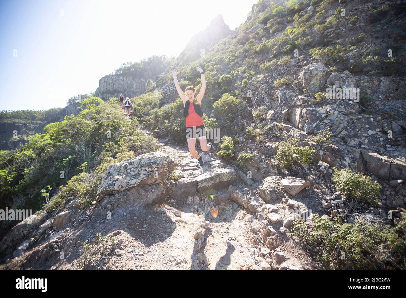 Woman jumping rock formation hi-res stock photography and images - Alamy