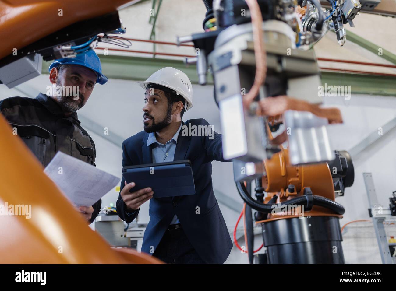 Engineering manager and mechanic worker doing routine check up in ...
