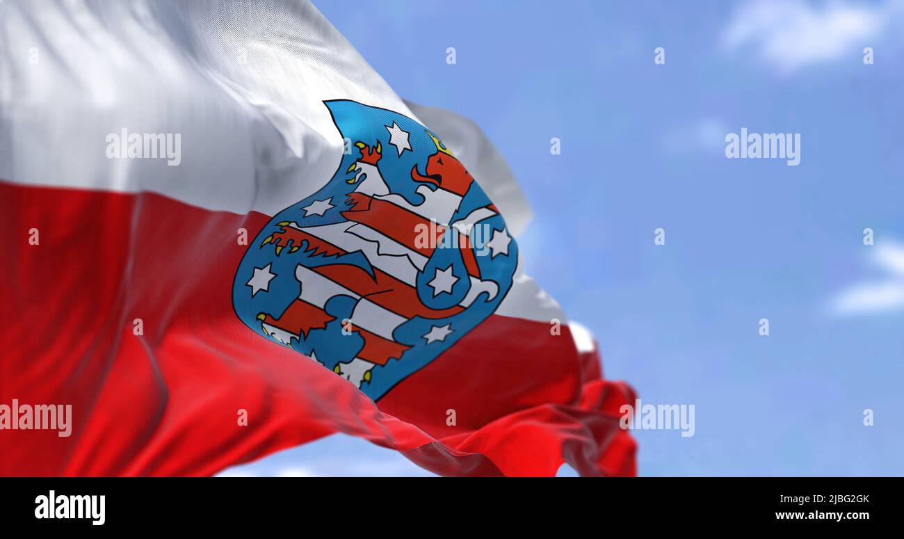 The flag of Thuringia waving in the wind on a clear day. Thuringia is a ...