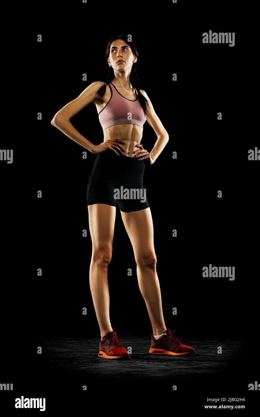 Portrait of young girl, female athlete in sports uniform posing ...