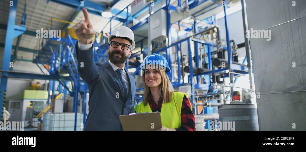 Engineering manager and mechanic worker doing routine check up in ...