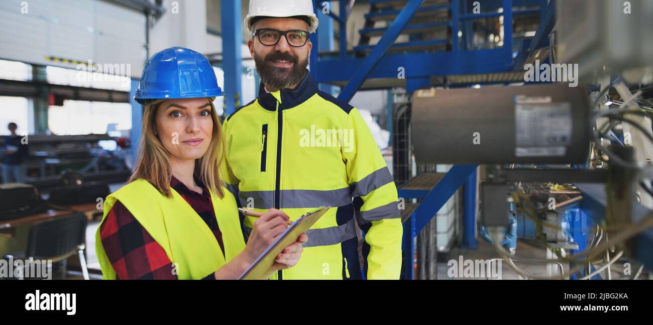 Engineering manager and mechanic worker doing routine check up in ...