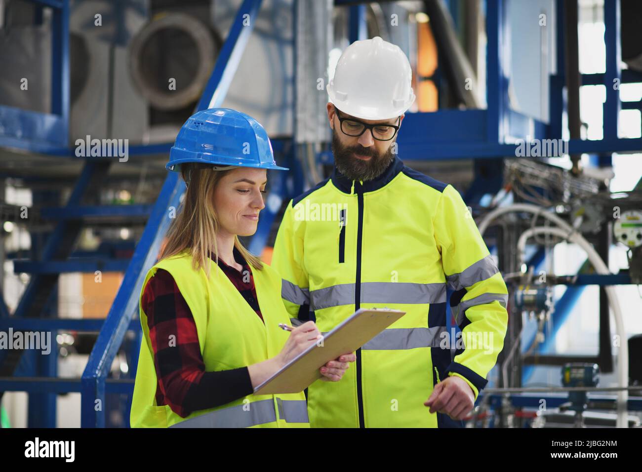 Engineering manager and mechanic worker doing routine check up in ...