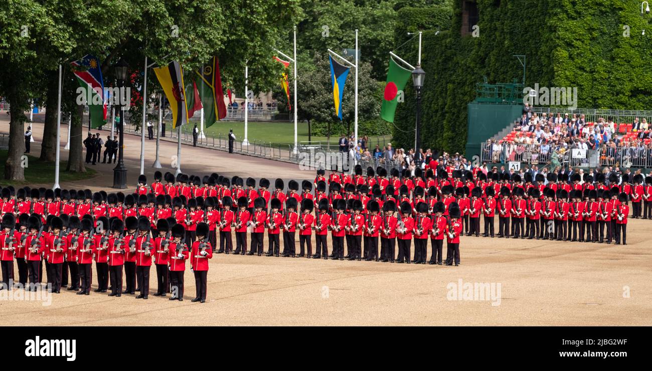 Guardsmen and women in black and red uniform marching at Horseguards ...