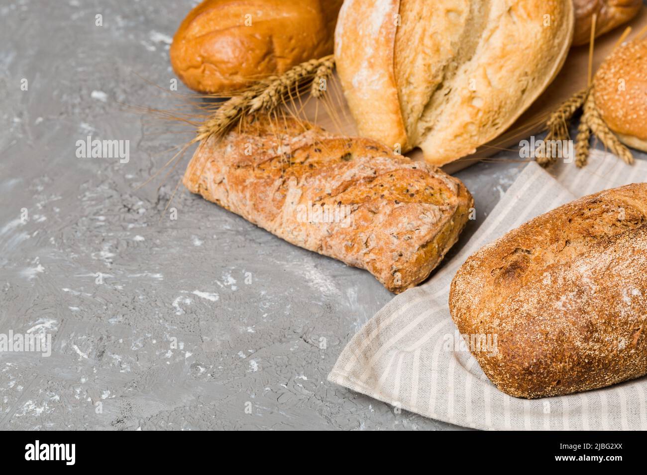Homemade natural breads. Different kinds of fresh bread as background ...