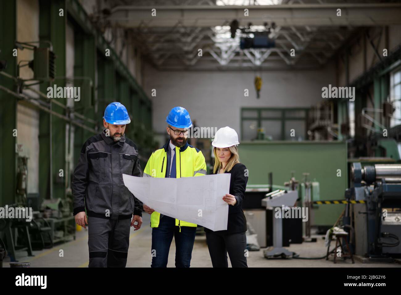 Manager supervisor, engineer and industrial worker in uniform ...