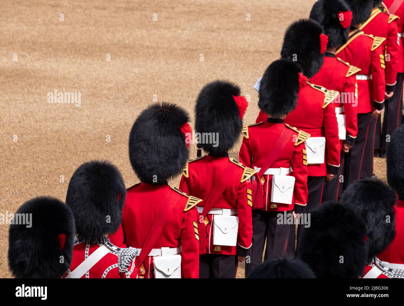 Guardsmen and women in black and red uniform marching at Horseguards ...