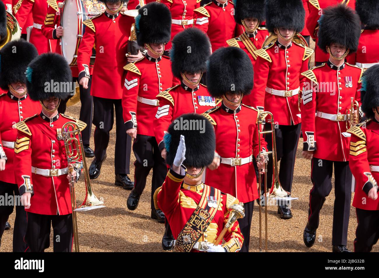 Guardsmen and women in black and red uniform marching at Horseguards ...