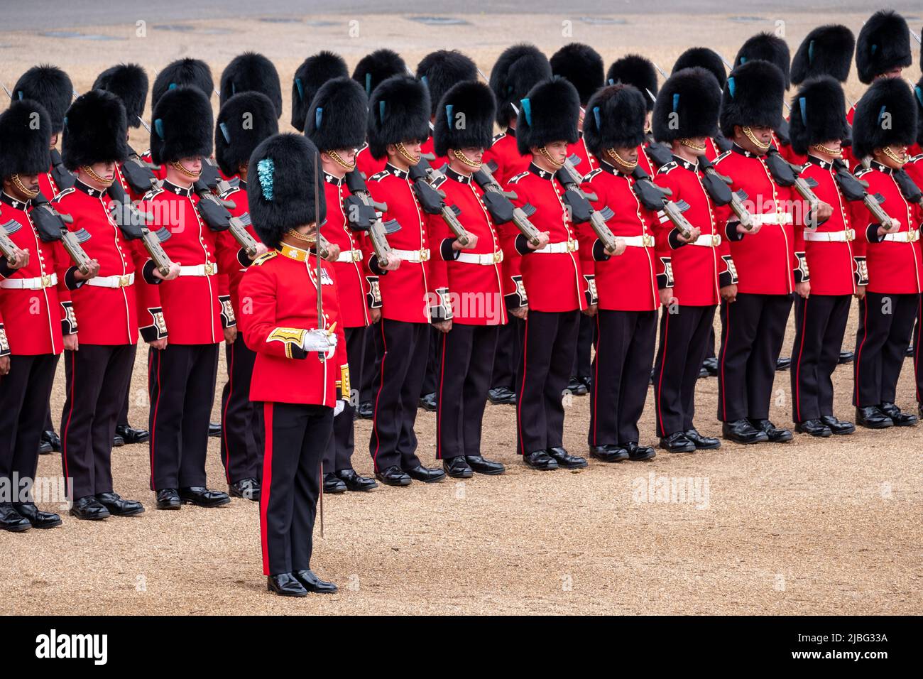 Guardsmen and women in black and red uniform marching at Horseguards ...