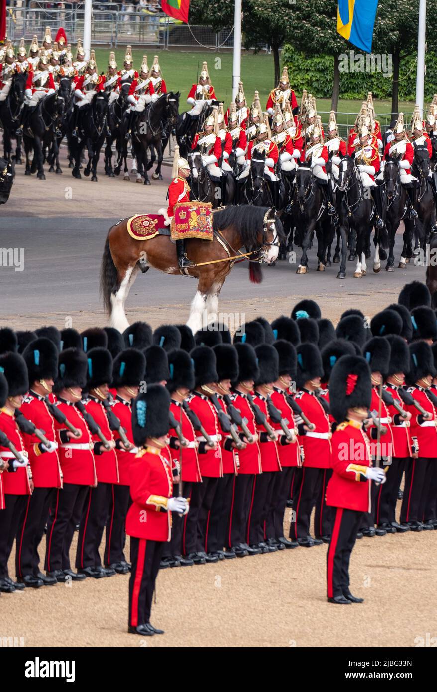Guardsmen and women in black and red uniform marching at Horseguards ...