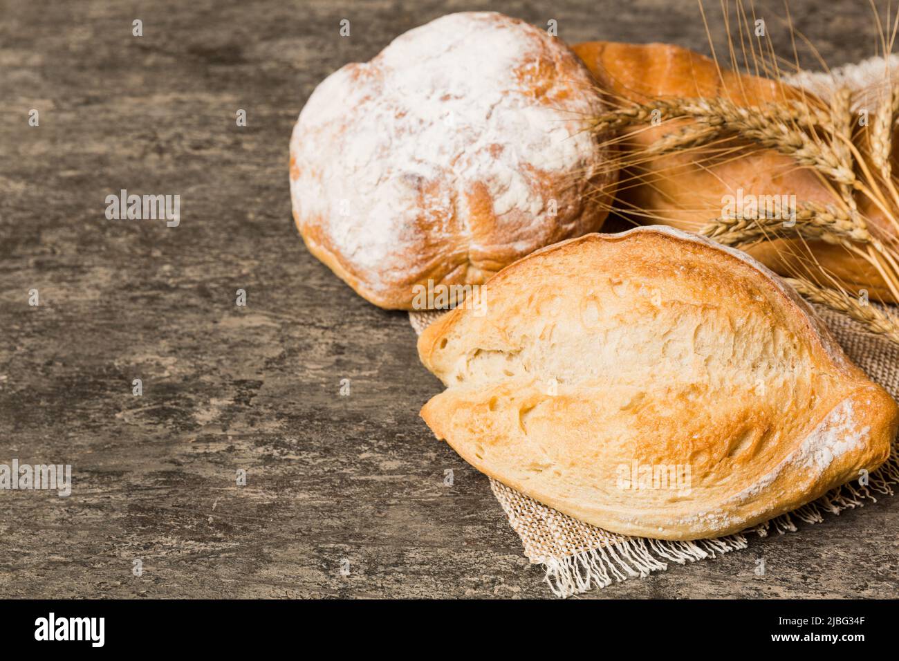 Homemade natural breads. Different kinds of fresh bread as background ...